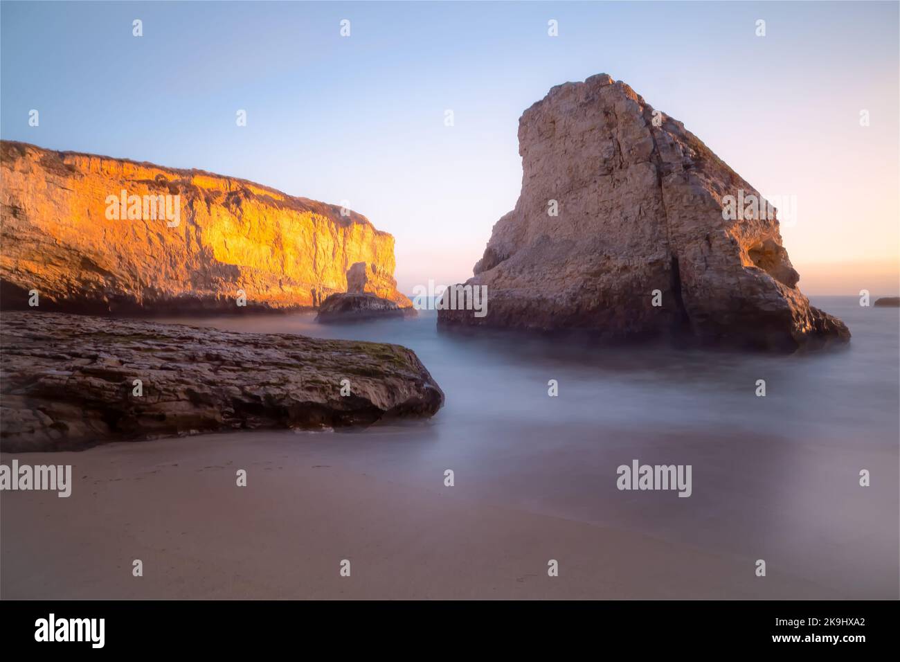 A breathtaking coastal scene with towering Shark Fin Rock rising from ...