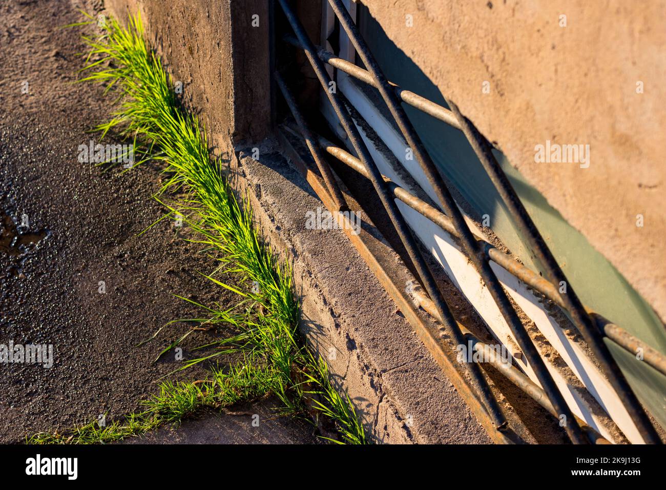 Fragment of the basement floor of a building with a small window closed ...