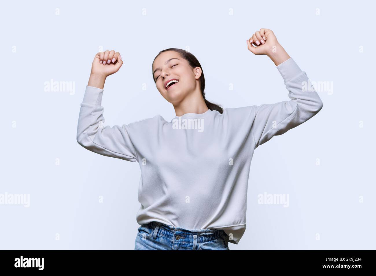 Cheerful dancing teenage girl on white studio background Stock Photo ...