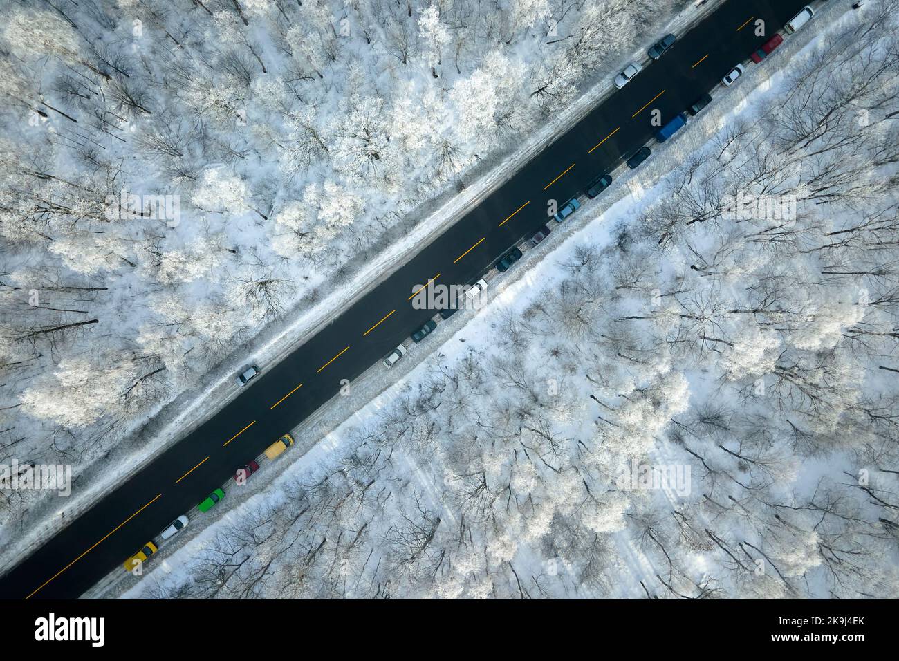 Aerial view of winter landscape with snow covered woods and black ...
