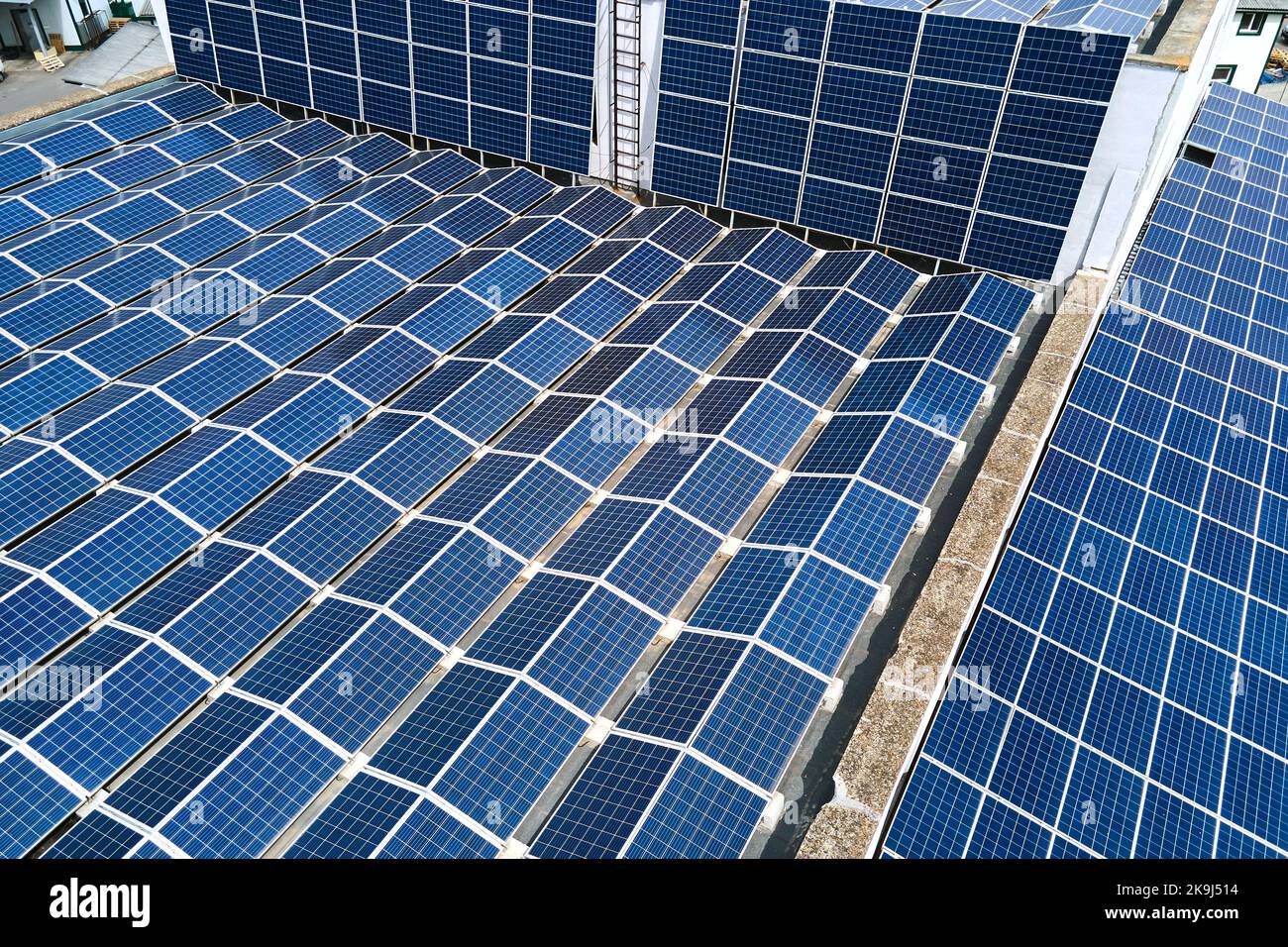 Aerial view of blue photovoltaic solar panels mounted on industrial ...