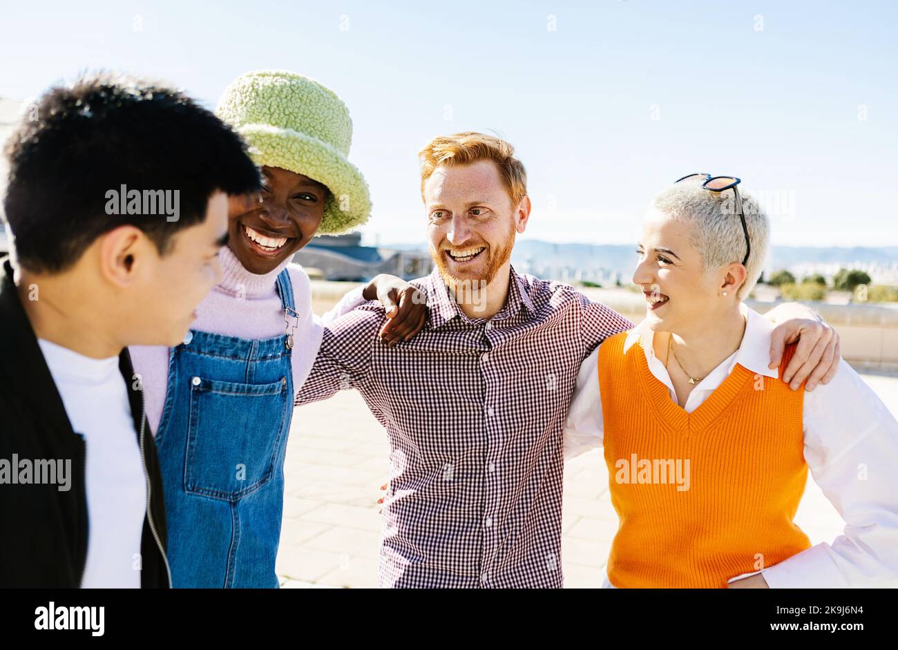 Four young multiracial friends having fun together outdoors Stock Photo - Alamy