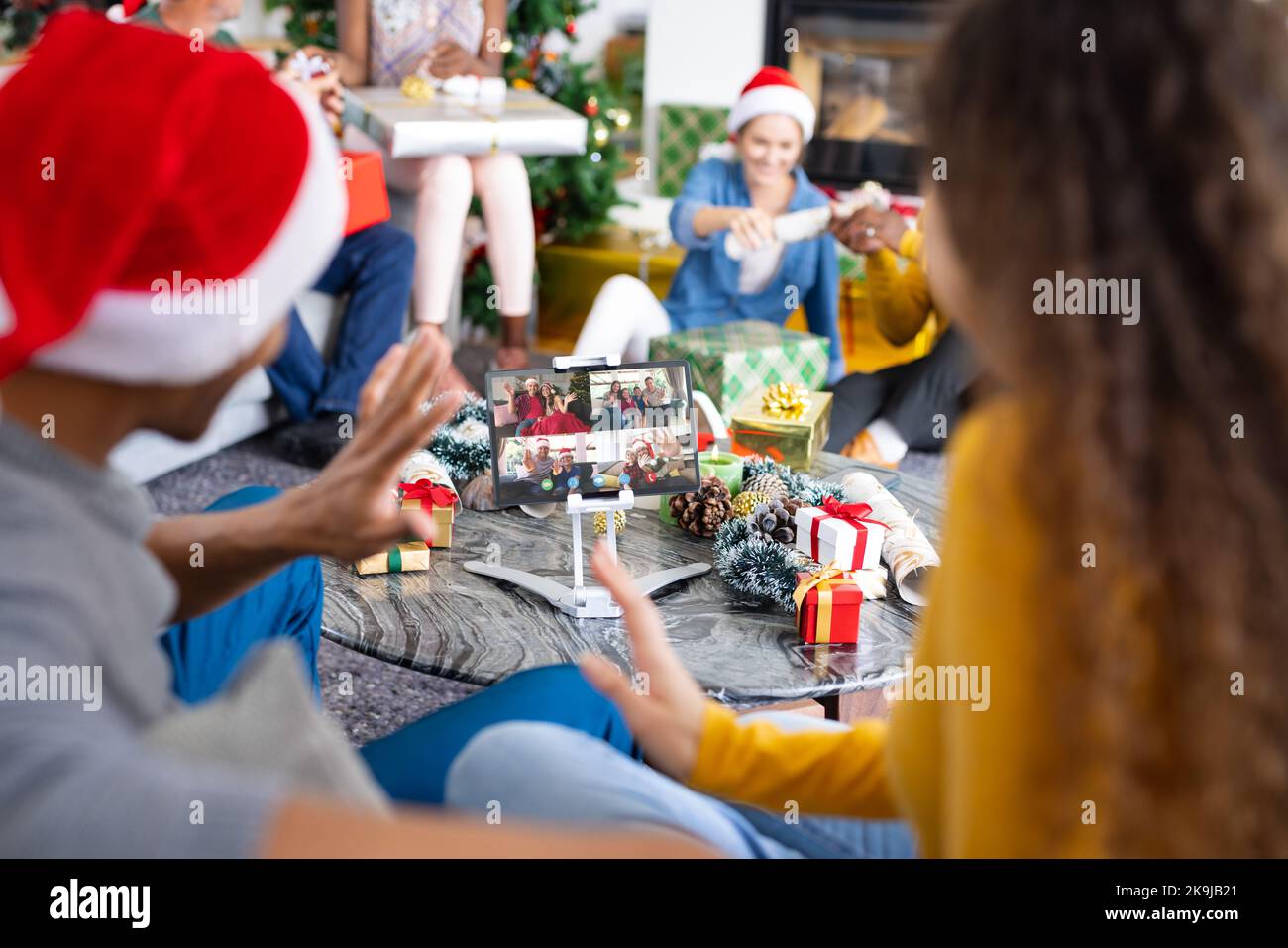 Diverse group of friends having christmas video call with diverse ...