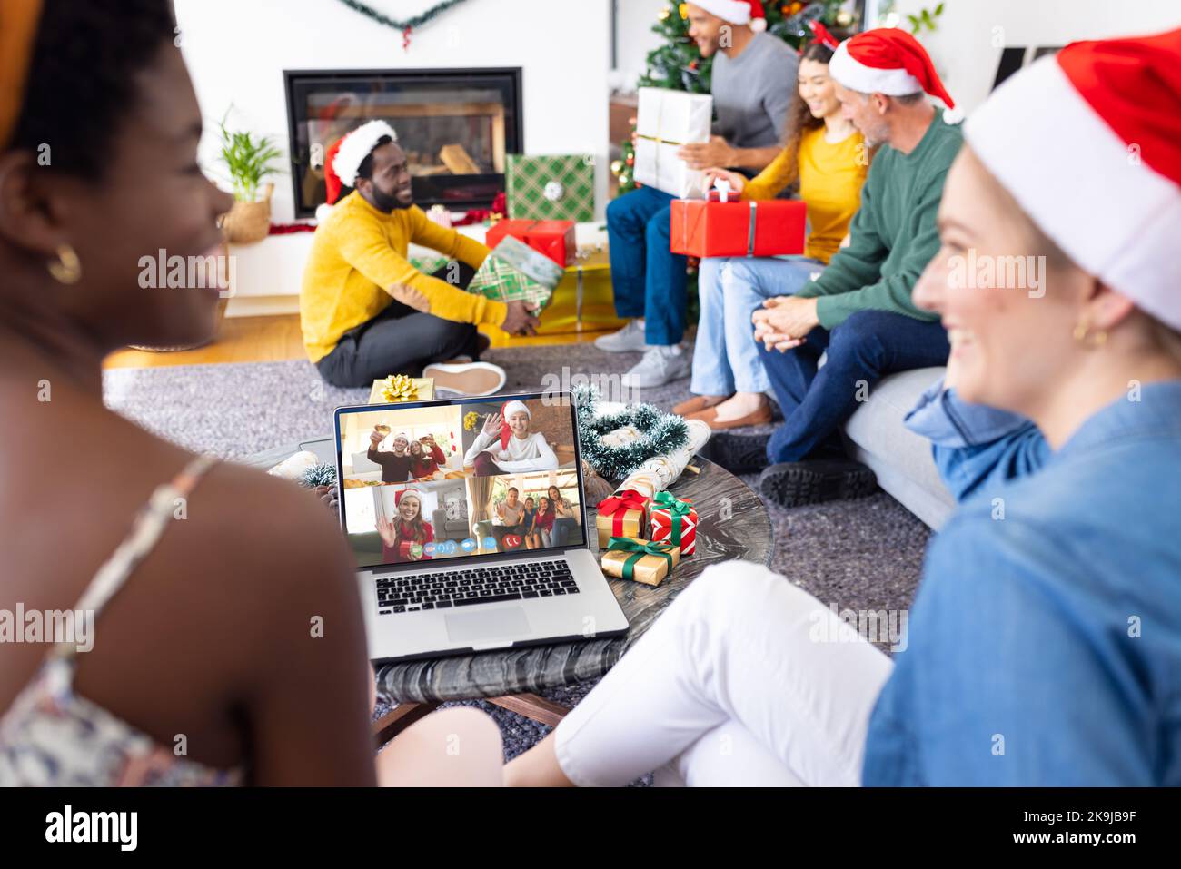 Diverse group of friends having christmas video call with diverse ...