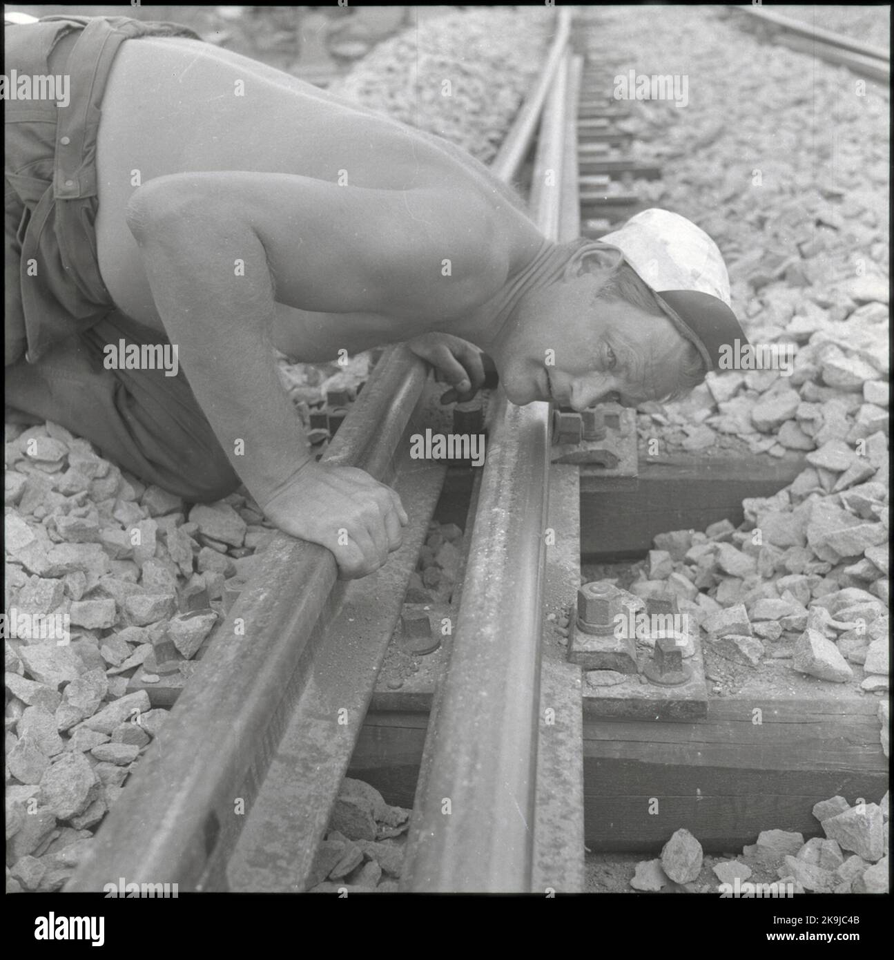 Track workers control the track position on the route Stock Photo - Alamy