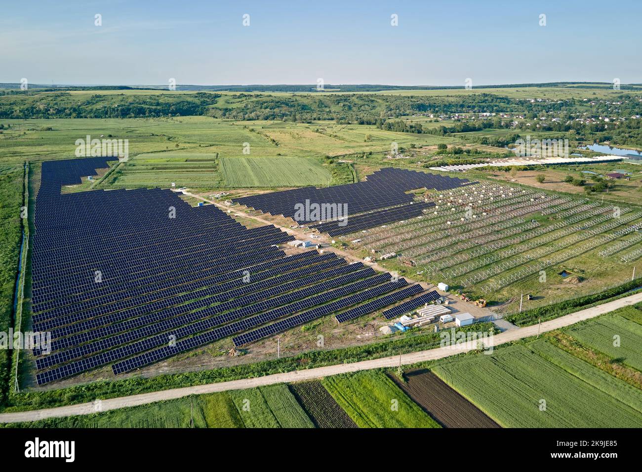 Aerial view of big electric power plant under construction with many ...