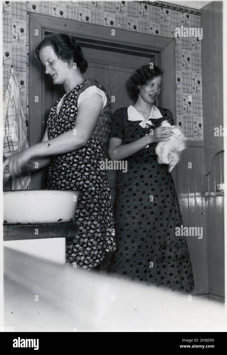 Siri at the sink. Sister Ingrid dries the disk Stock Photo - Alamy