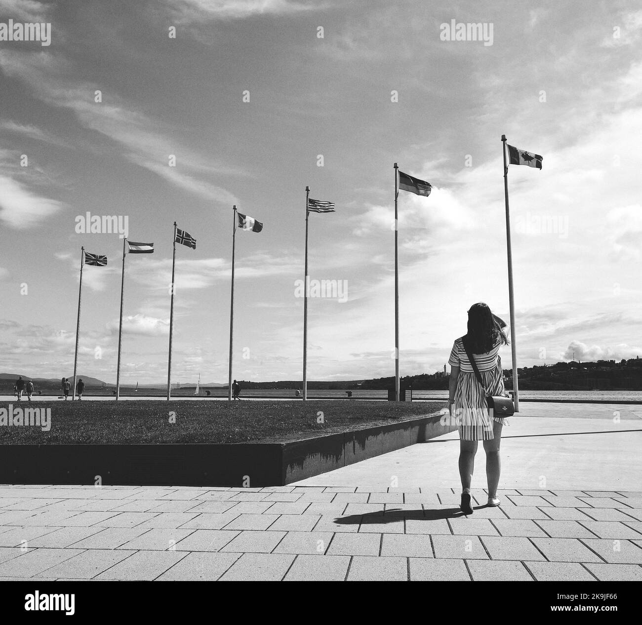 Woman Walking By Flags Stock Photo - Alamy