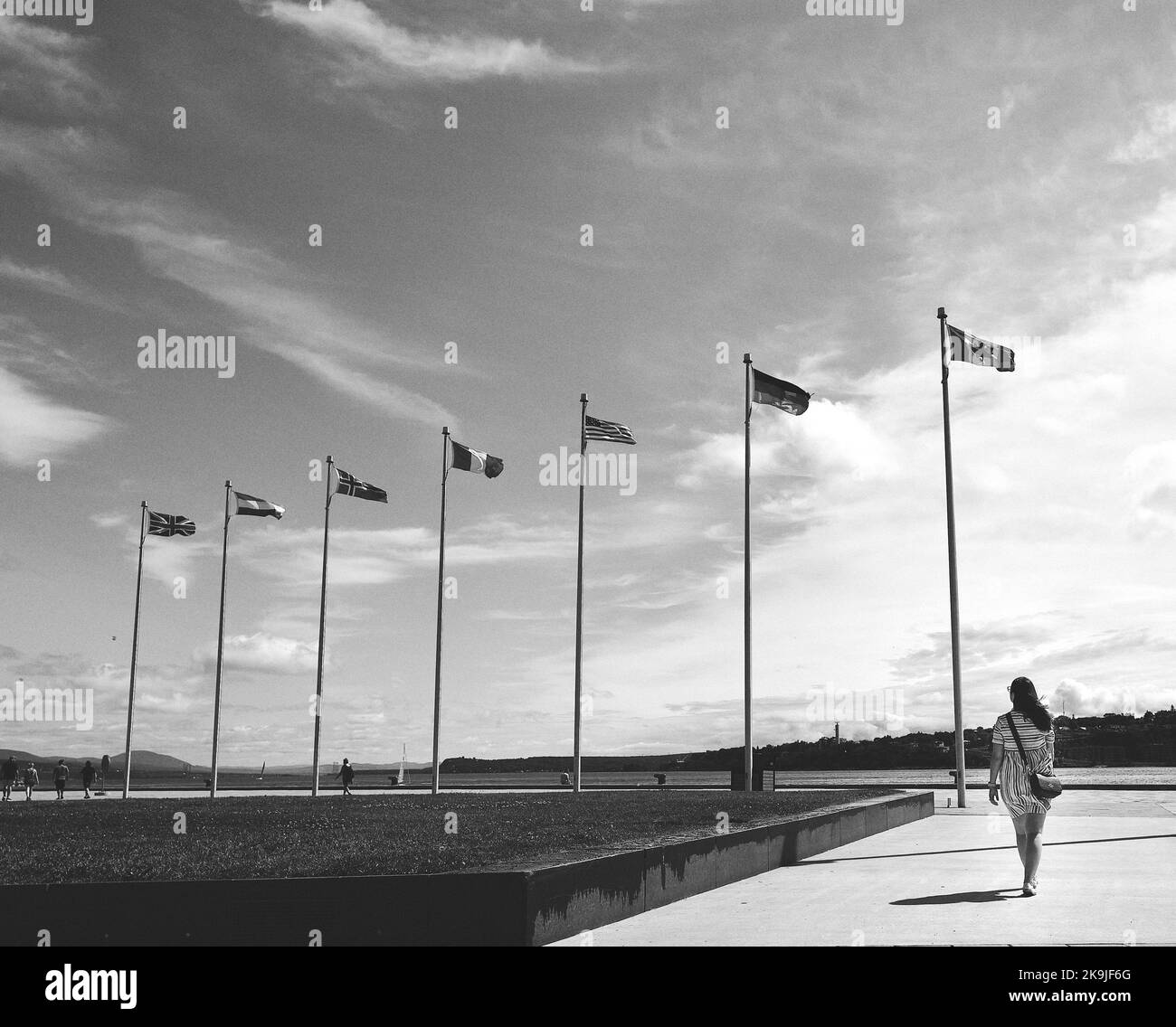 Pedestrian Walking By Flags Stock Photo - Alamy