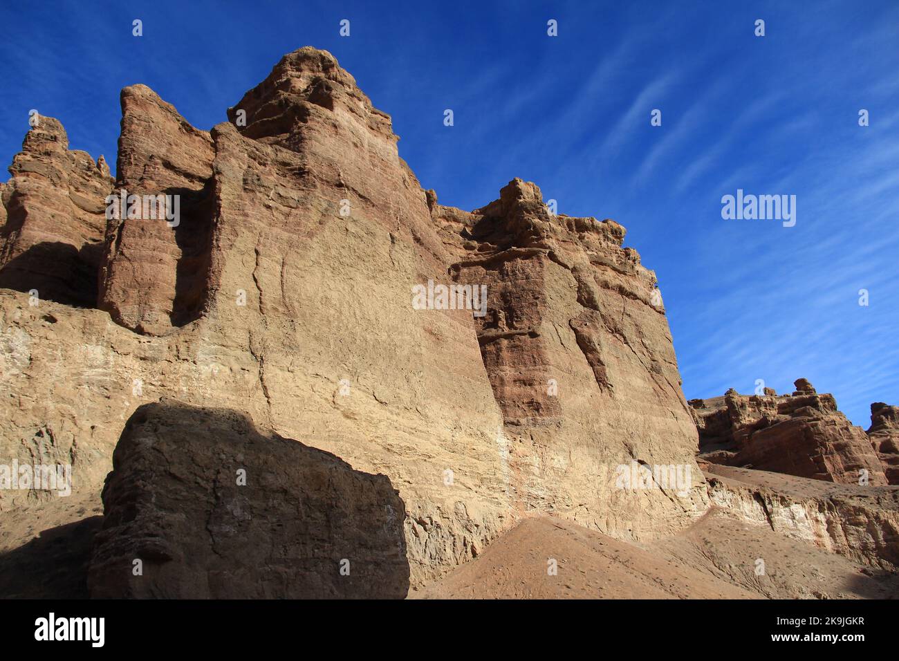High steep sandy-clay rocks of the Charyn canyon against the sky with ...