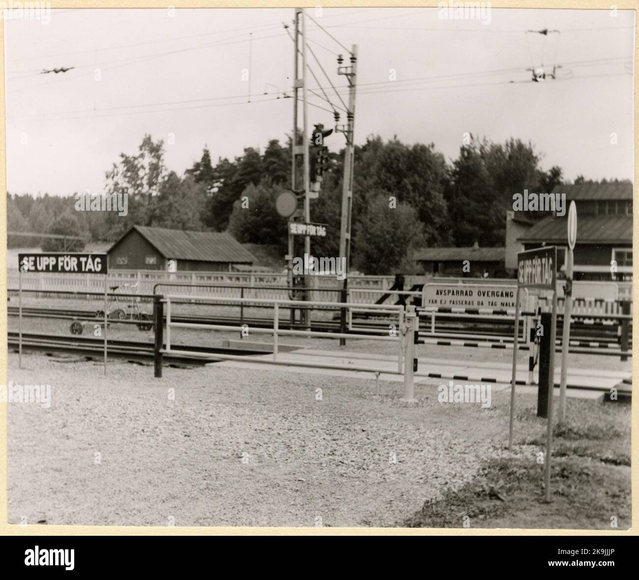 Railway crossing with a barrier gate Stock Photo - Alamy