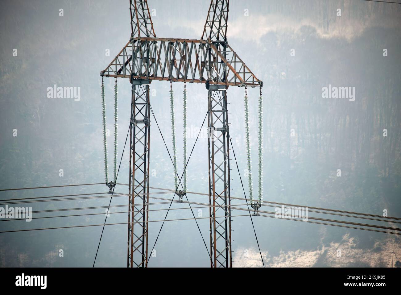 High voltage tower with electric power lines divided by safe guard ...