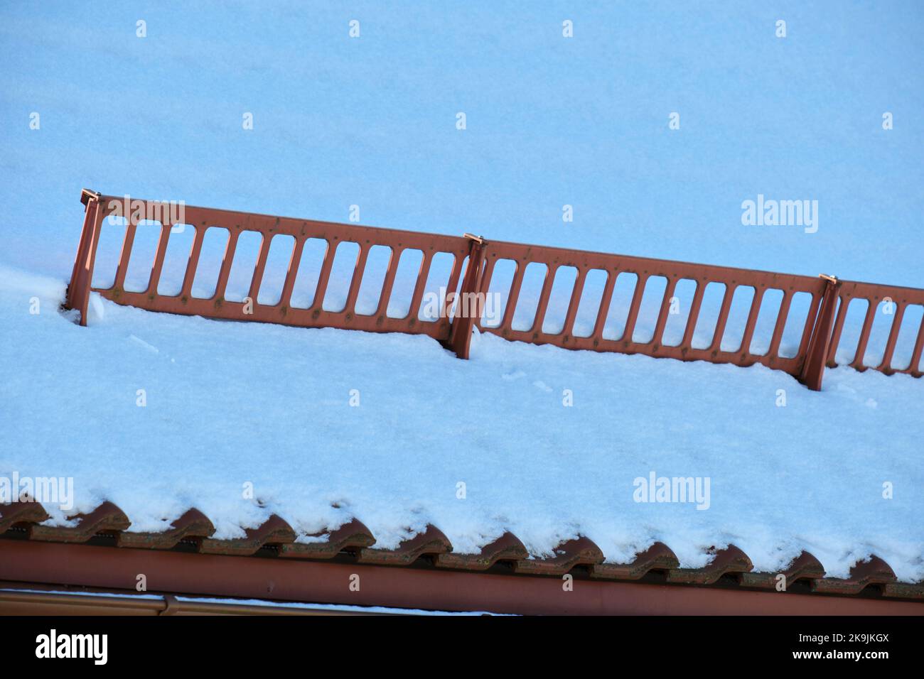 Snow guard for safety in winter on house roof top covered with ceramic ...