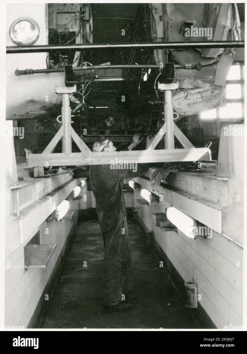 Vehicle mechanics work under a crash -damaged bus Stock Photo - Alamy