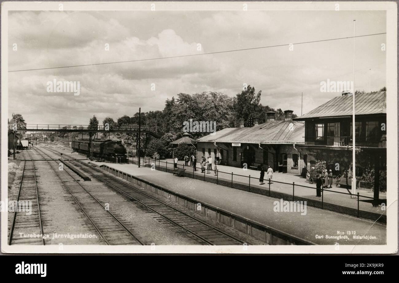 Station area and yard with arriving trains and traveling on platform ...