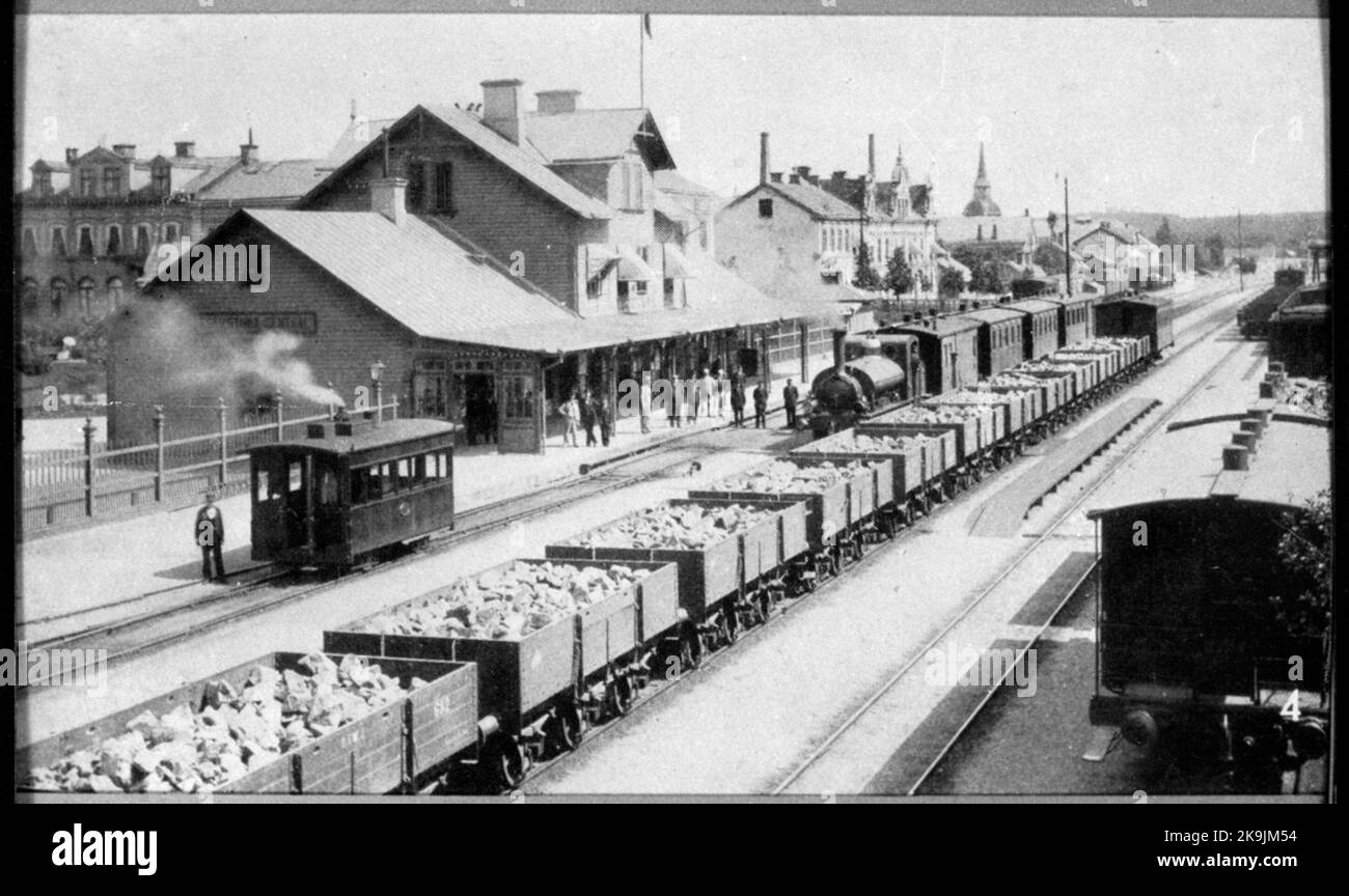 Personnel outside Eskilstuna Railway station with ore train and ...