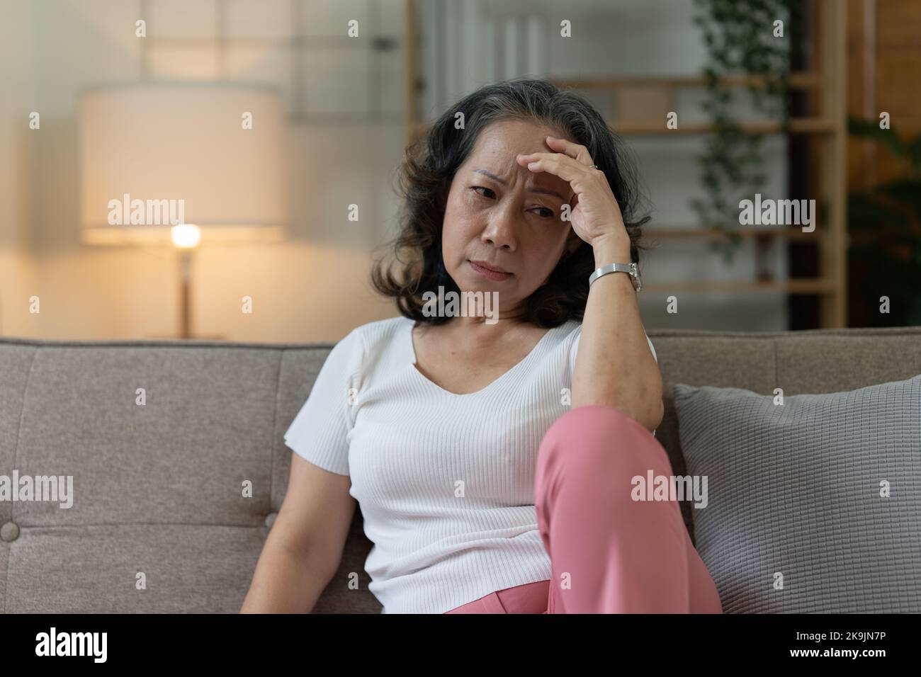 Depressed Elderly Asian woman sitting alone at home. Retired woman ...