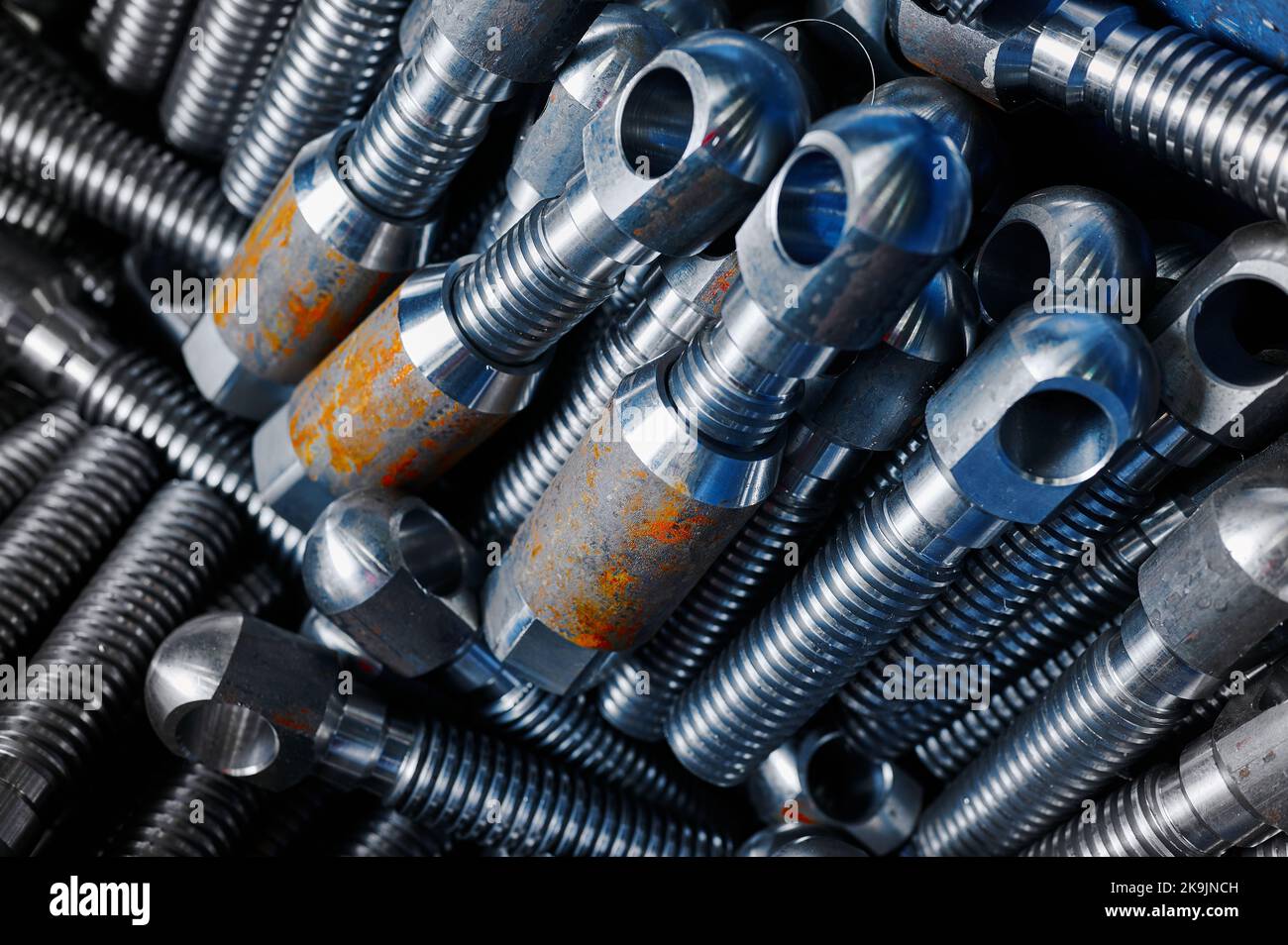 Large crank pins with nuts pile in warehouse macro view Stock Photo - Alamy