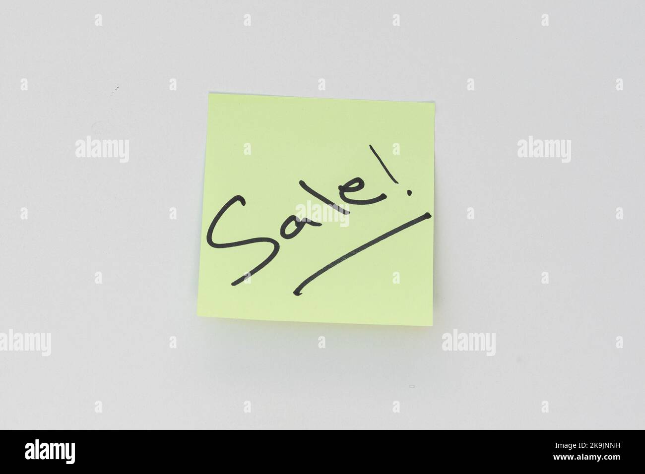 Sale word hand written on a yellow sticky note isolated on white ...