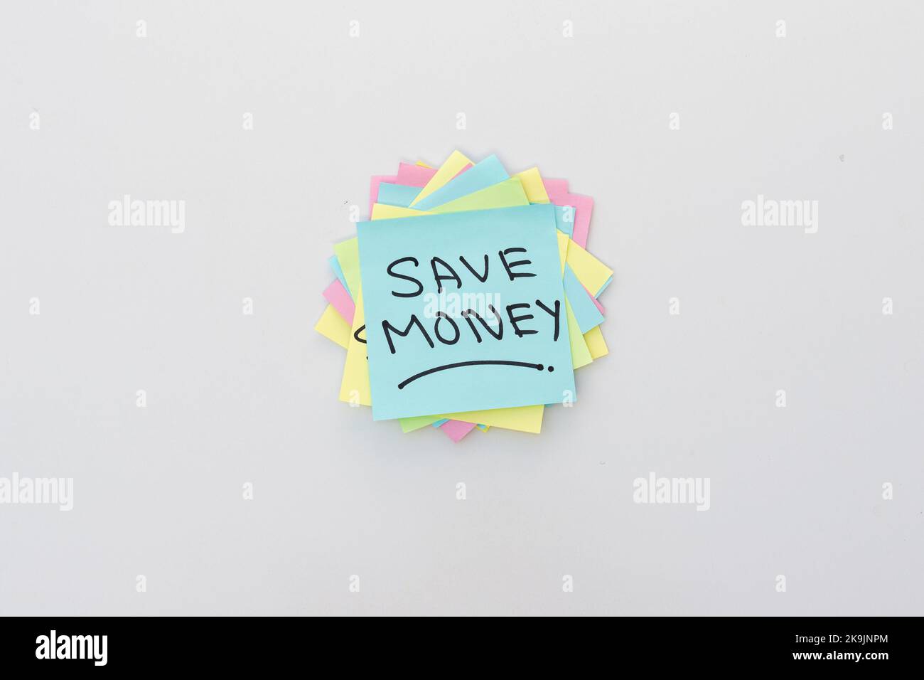 Save money text hand written on a sticky note with isolated white ...
