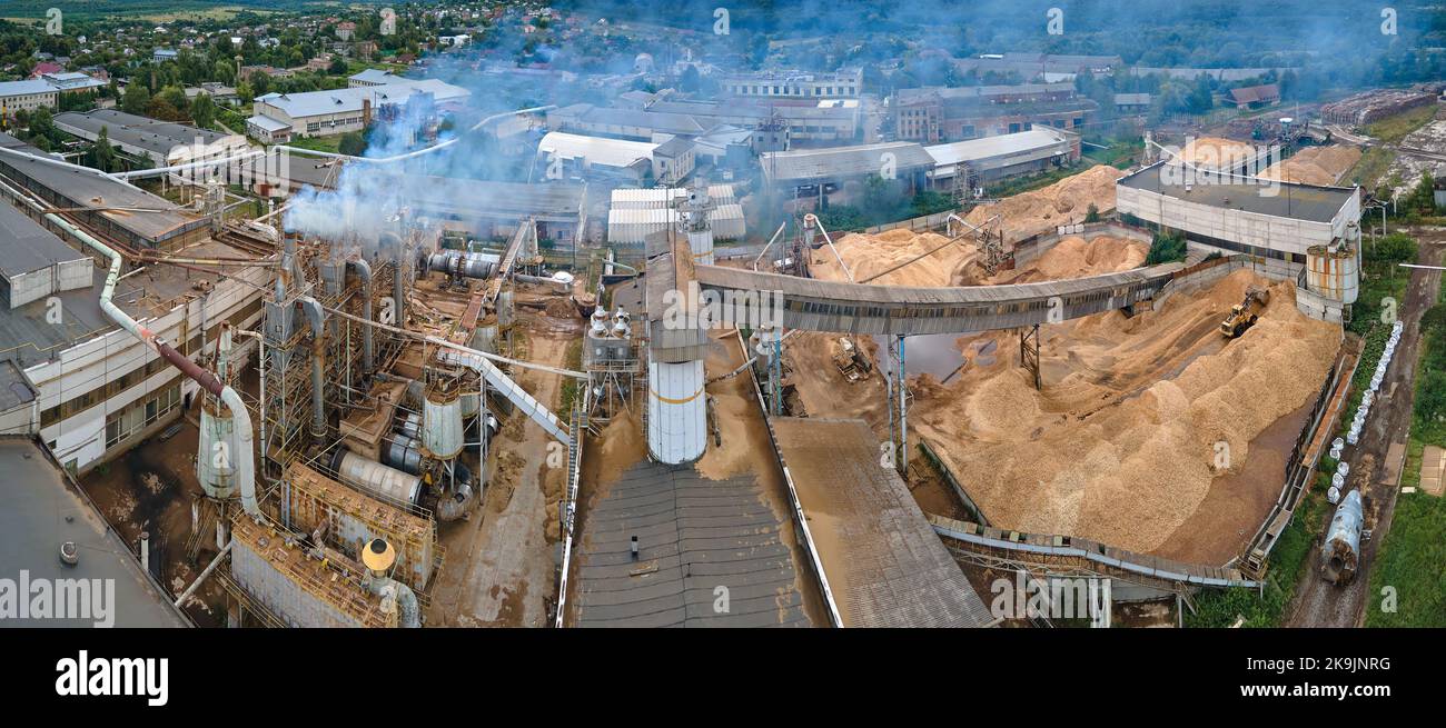 Aerial view of wood processing plant with smokestack from production ...