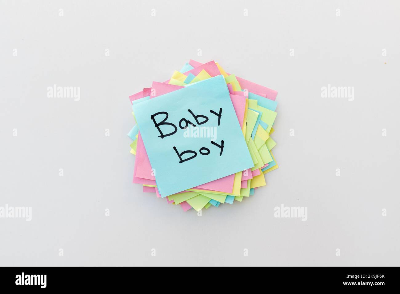 Gender reveals baby boy handwritten note on white isolated background ...