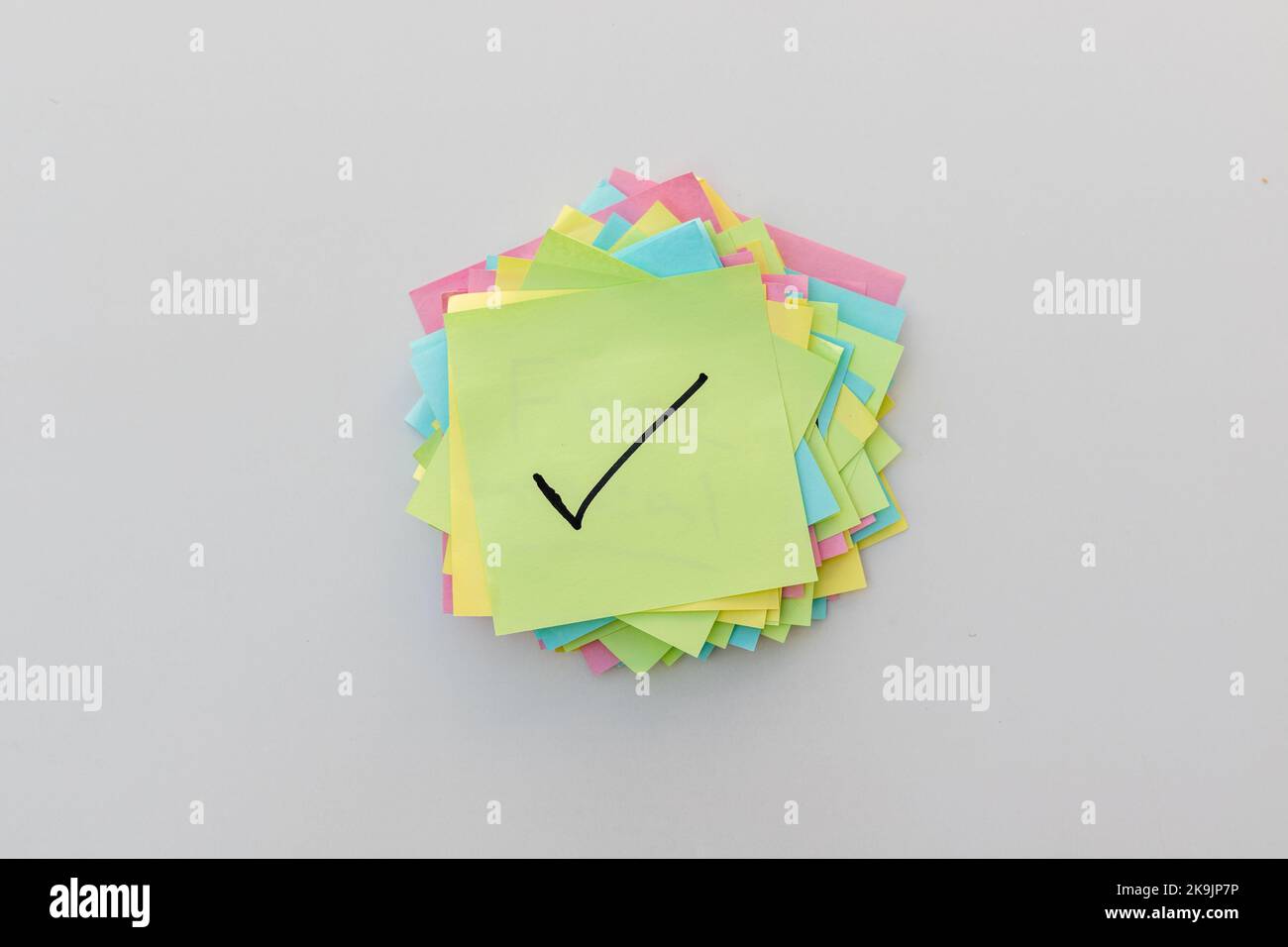 Hand written right tick on a sticky note on isolated white background ...