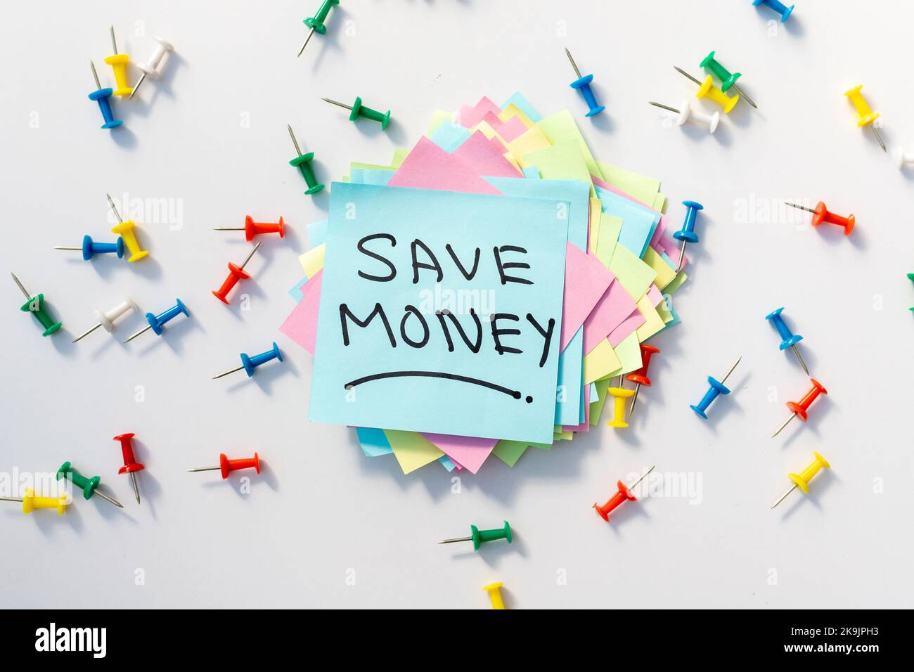 Save Money sticky note with a colorful push pins and white background ...