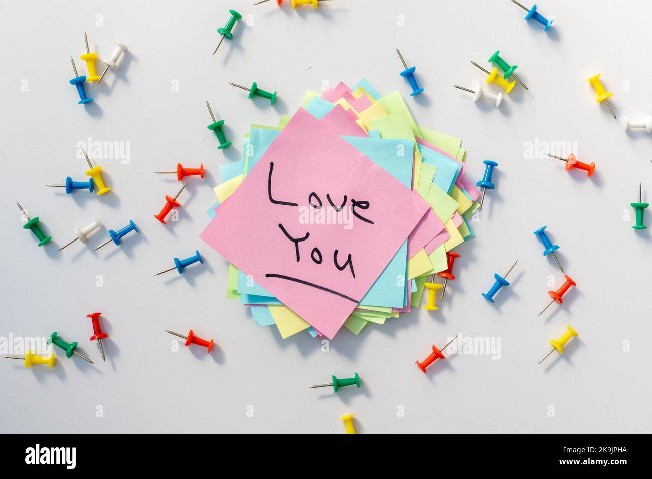 Love you postcard handwritten on a sticky note Stock Photo - Alamy