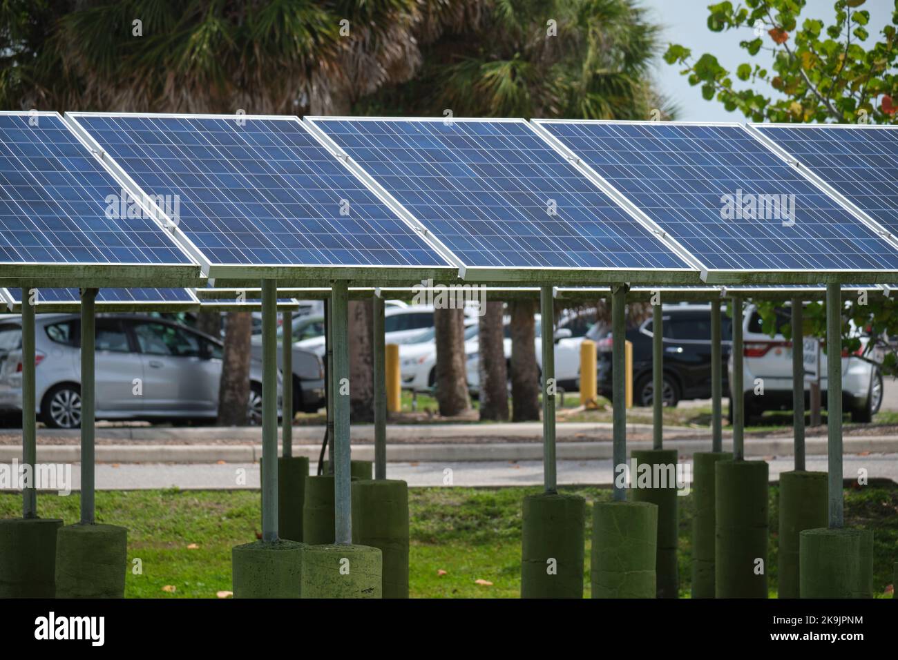 Solar panels installed on stand frame near parking lot for effective ...