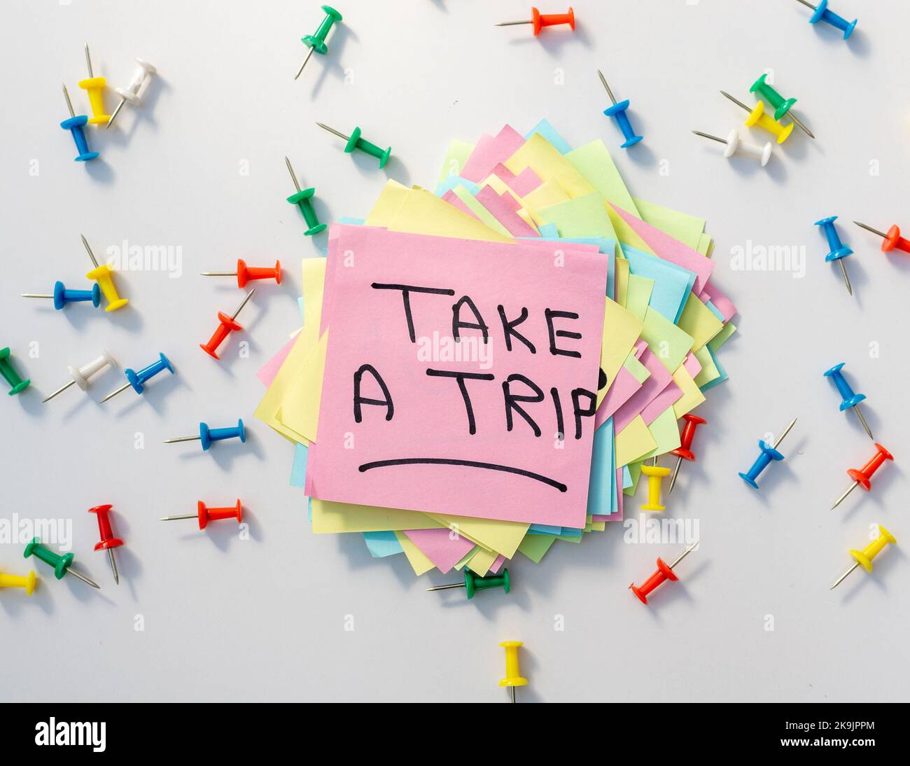 Take a trip handwritten word on a sticky note Stock Photo - Alamy