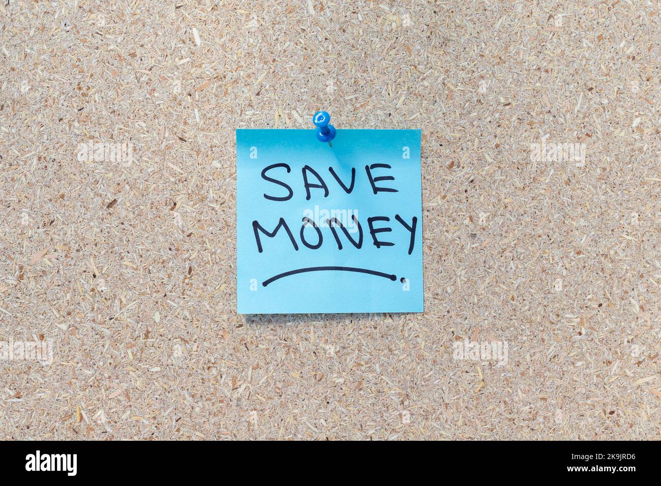 Save Money hand written note on a cork board background with copy space ...