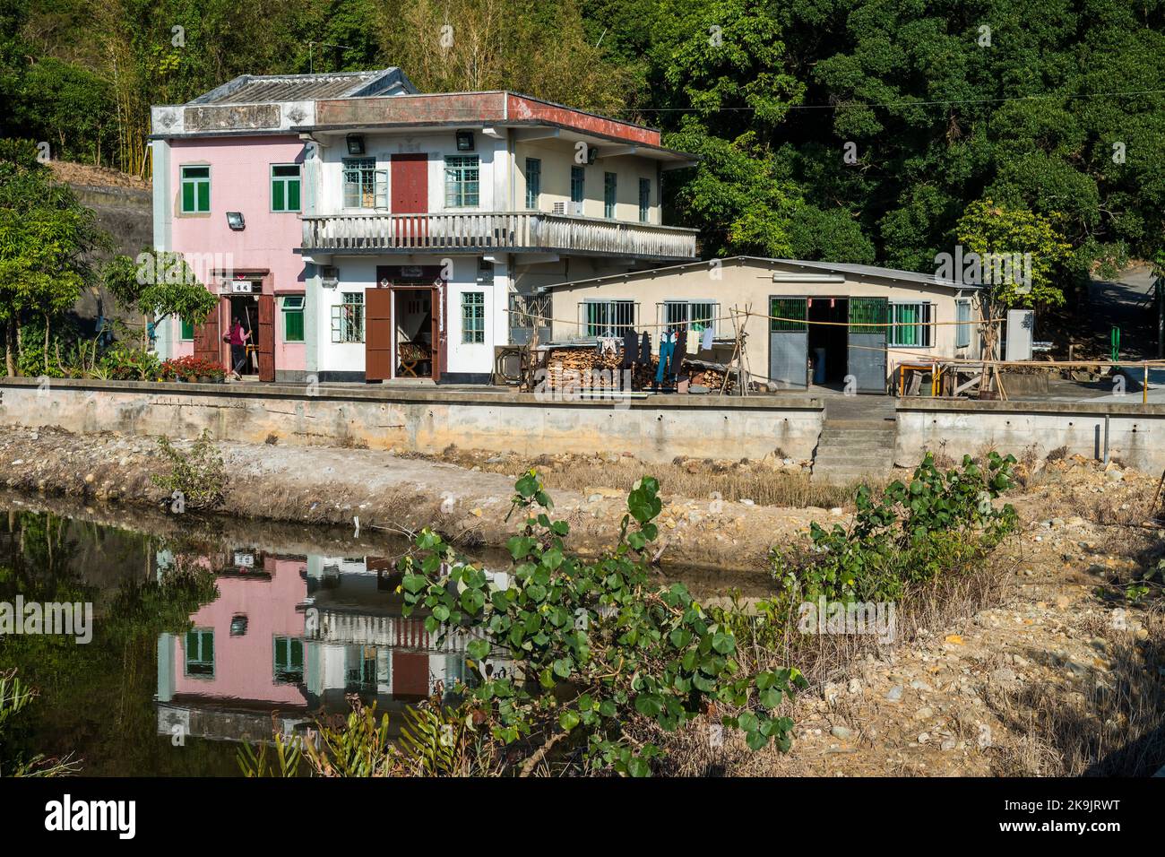 Traditional Chinese village houses with a man-made pond, Tung O Ancient ...