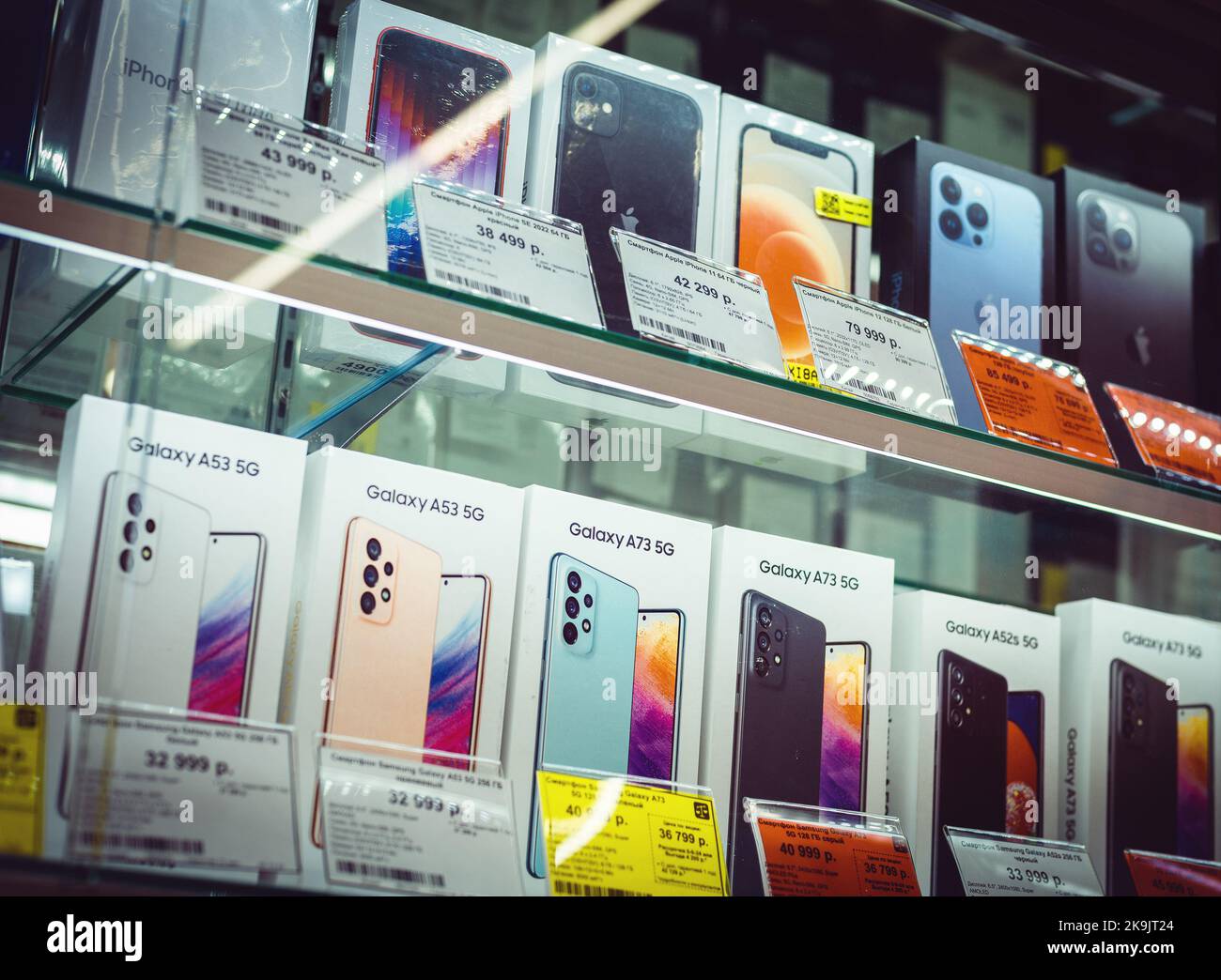 brand new smartphones Samsung Galaxy and iPhone are sold at glass ...