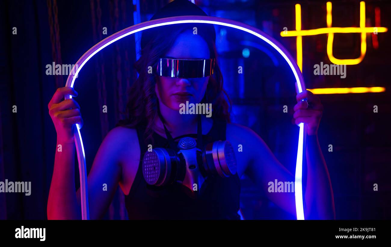 Caucasian woman in sunglasses posing in neon studio Stock Photo - Alamy