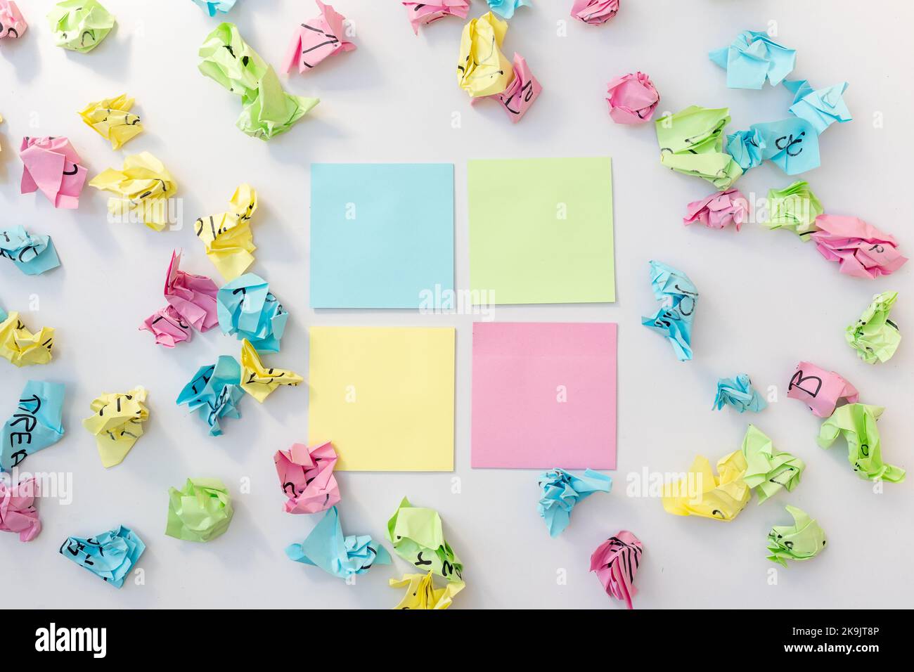 Blank sticky notes with crumbled paper balls on white isolated ...