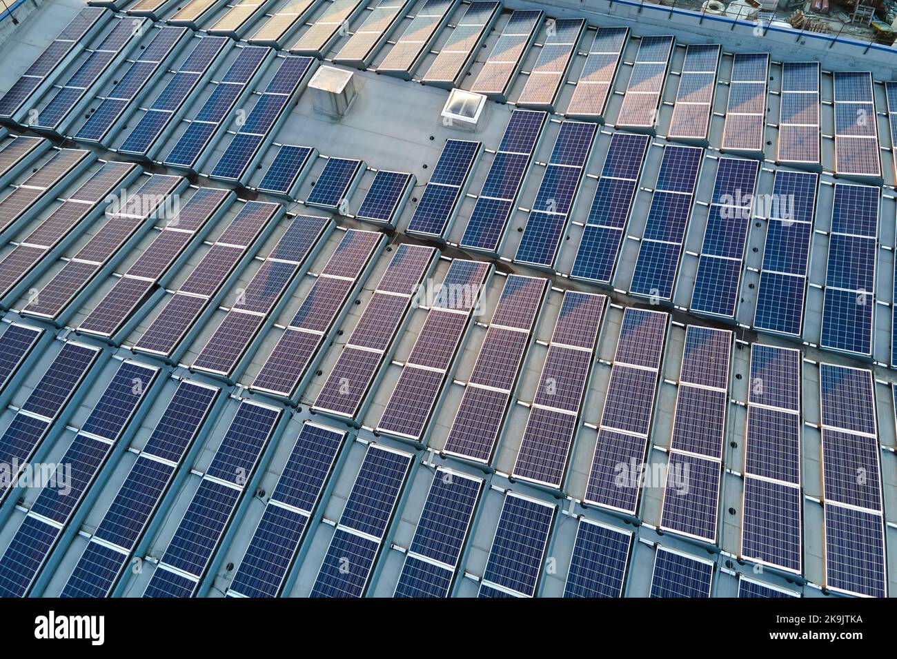 Aerial view of solar power plant with blue photovoltaic panels mounted ...