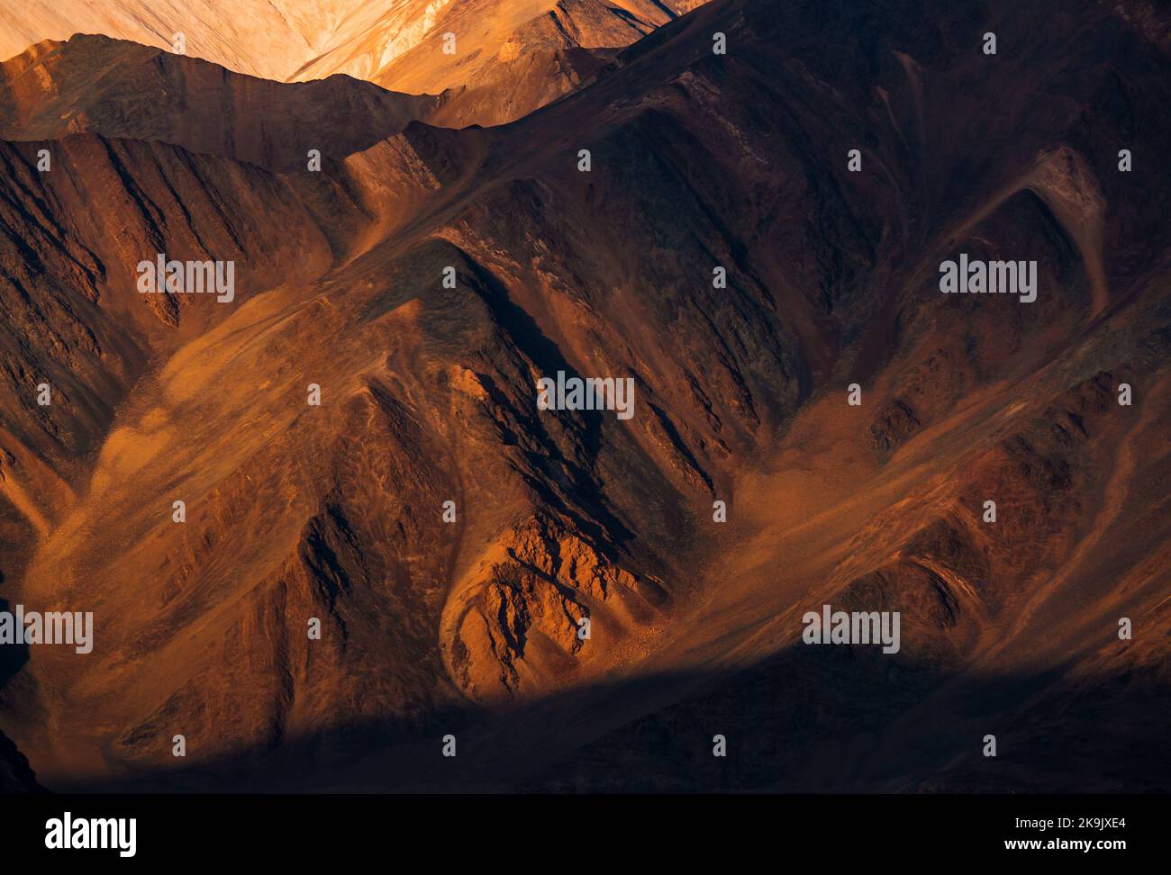 Stone texture on a mountain face with sun light. Shadows and Highlights ...