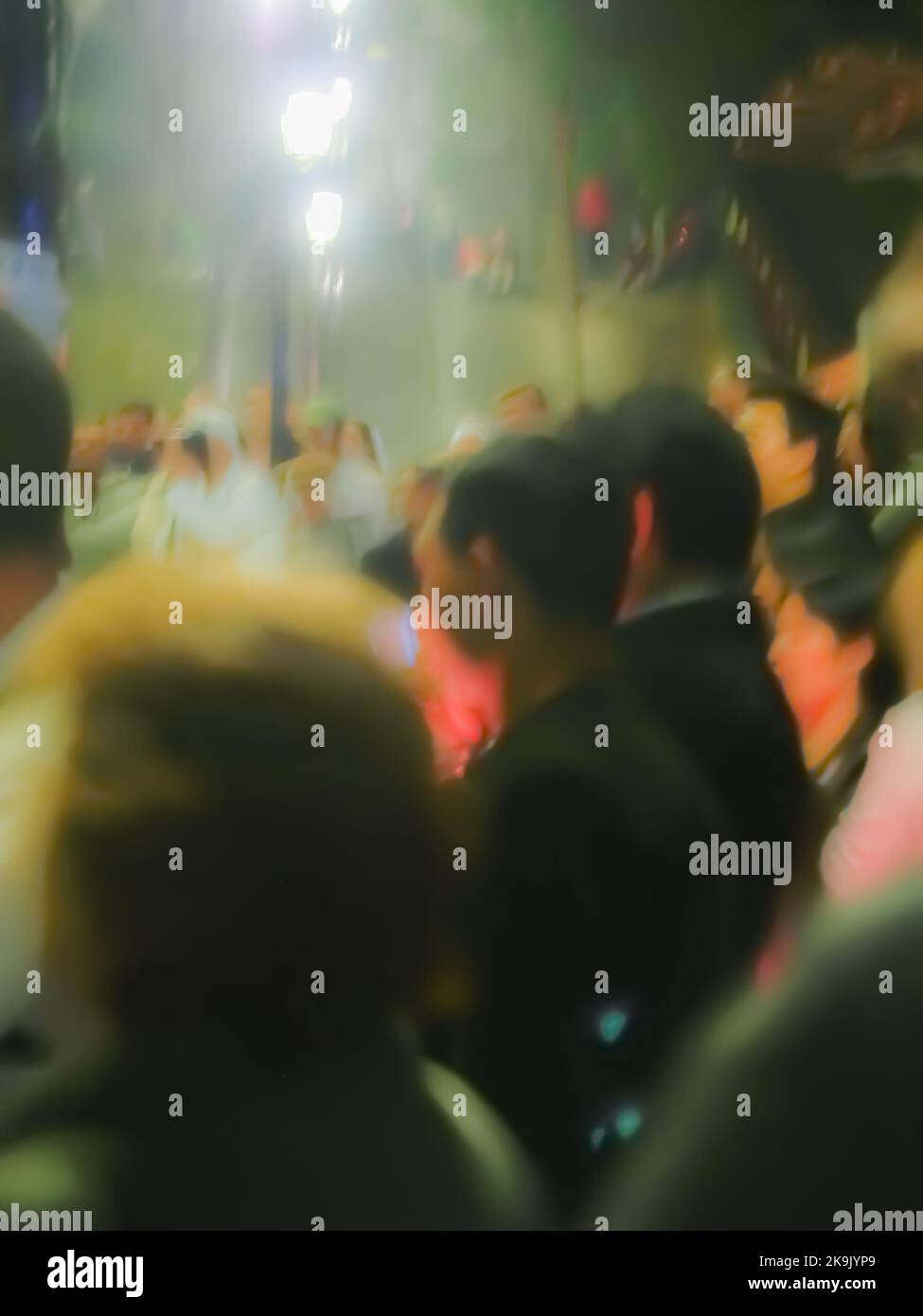 Urban crowd in painterly blurred effect watching an event in street in ...