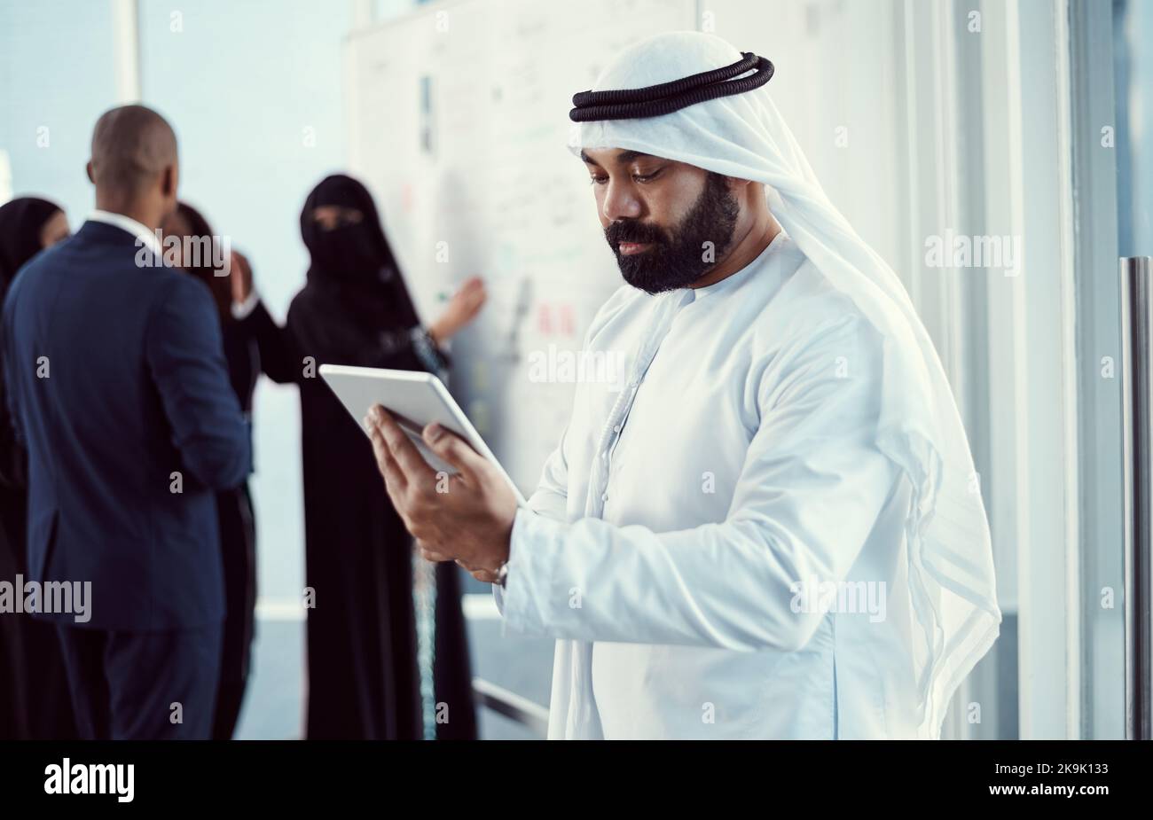 Technology makes the business world tick. a handsome mature arabic ...