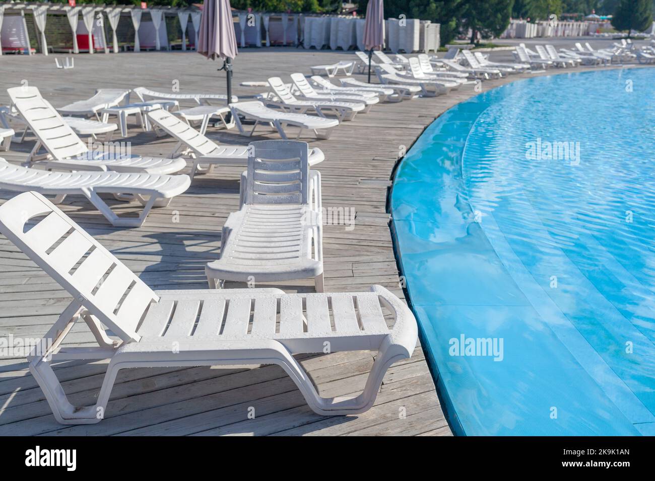 A large swimming pool with clear water in the open air against the ...