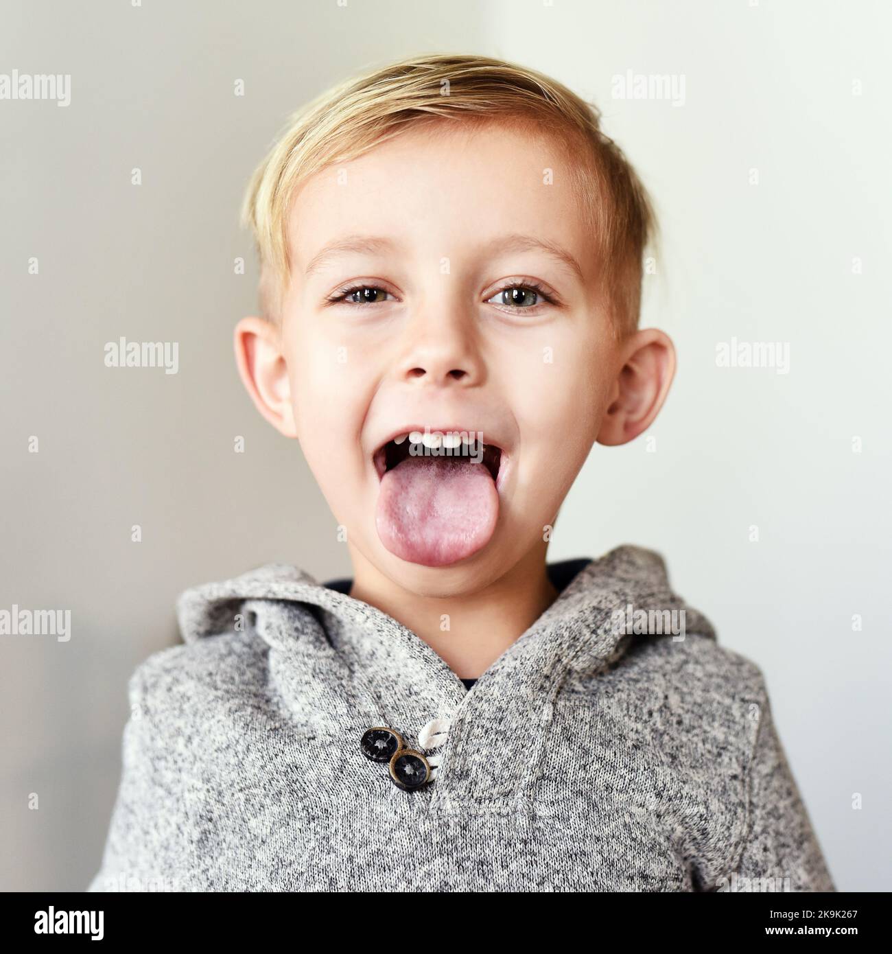 Say Aaaaah Portrait Of A Cheerful Little Boy Sticking His Tongue Out