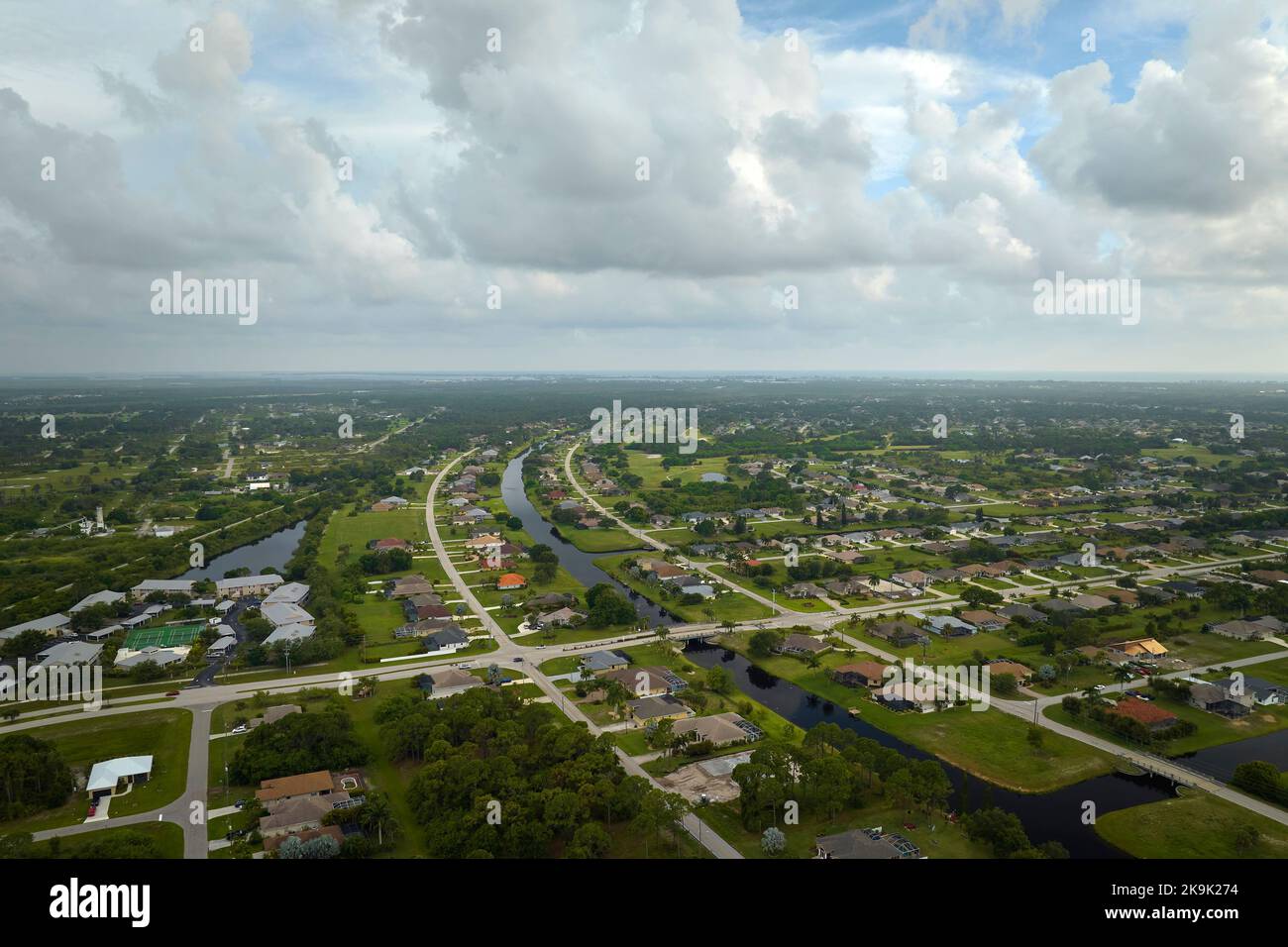 Aerial landscape view of suburban private houses between green palm ...
