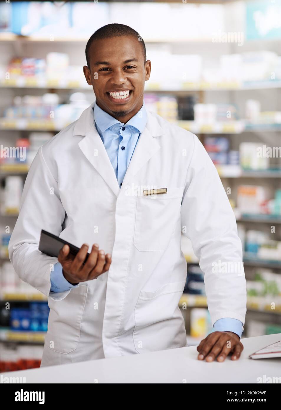 Your wellbeing always comes first. Portrait of a young pharmacist ...