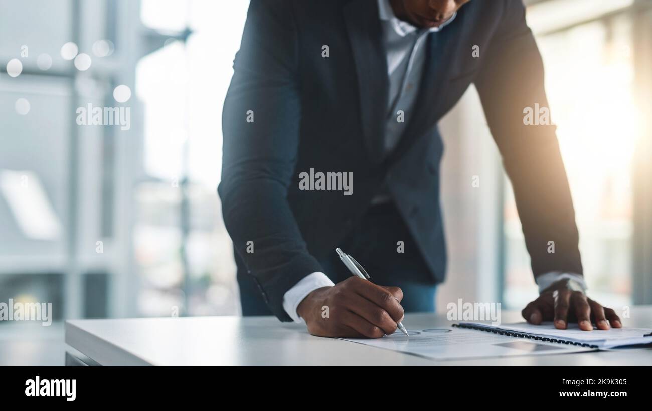 One last thing. an unrecognizable young businessman taking notes while ...