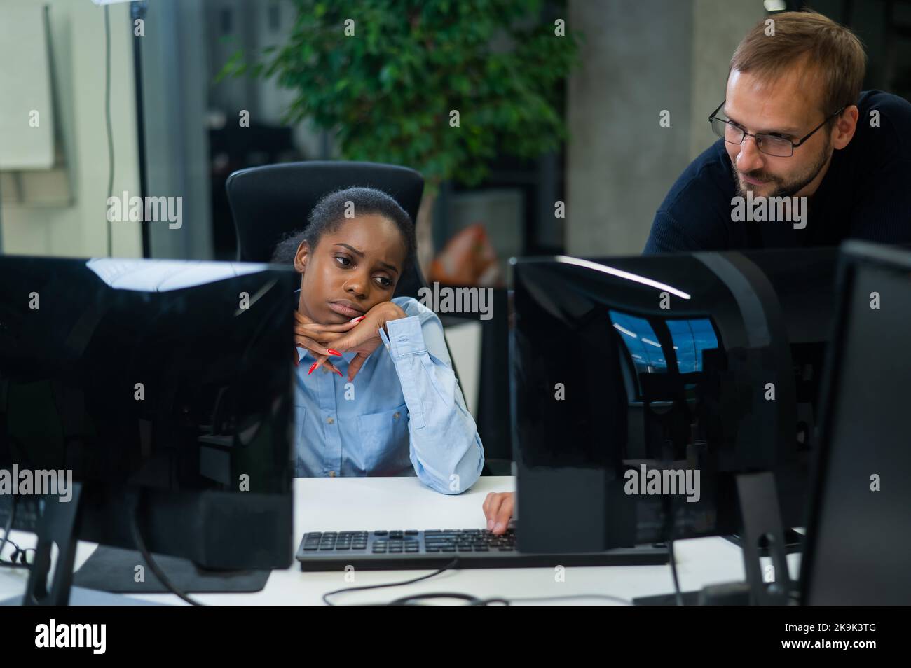 Colleagues look at the monitor and decide working moments. Caucasian ...