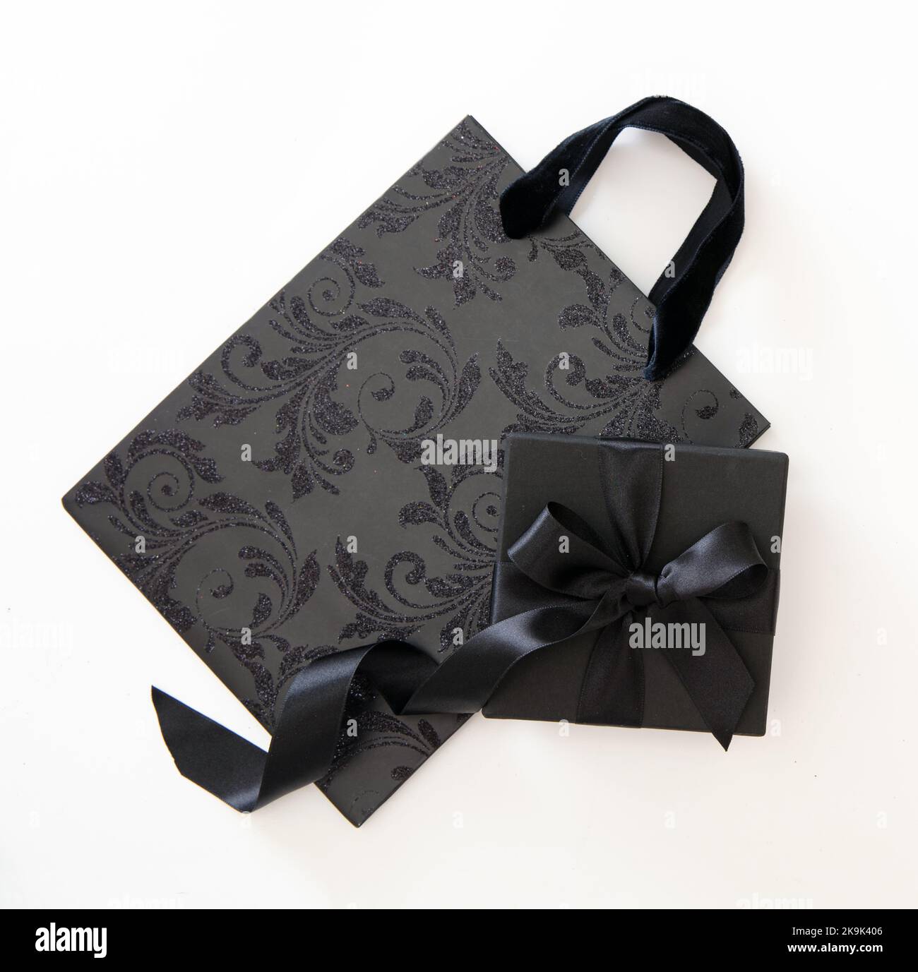 Black Friday sale concept. Shopping paper bag and gift box with curly ...