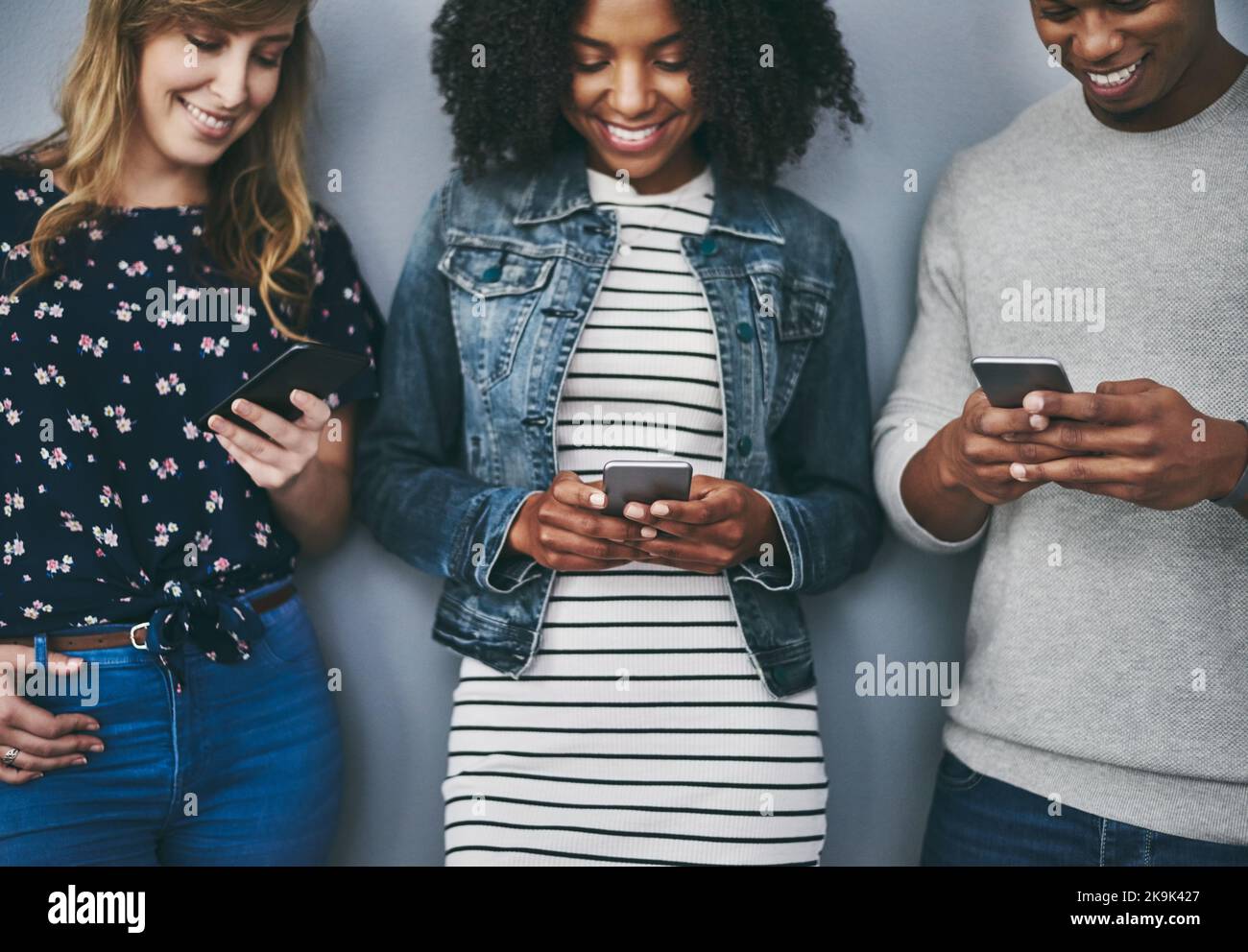 Are you guys connected to the wifi. Studio shot of three young people ...