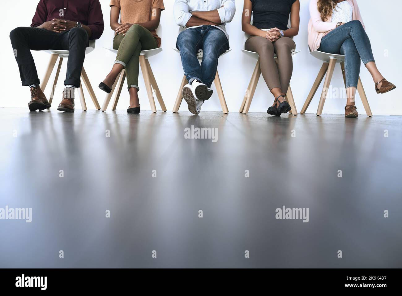 Theyve made the cut. a group of diverse people waiting in line to be ...