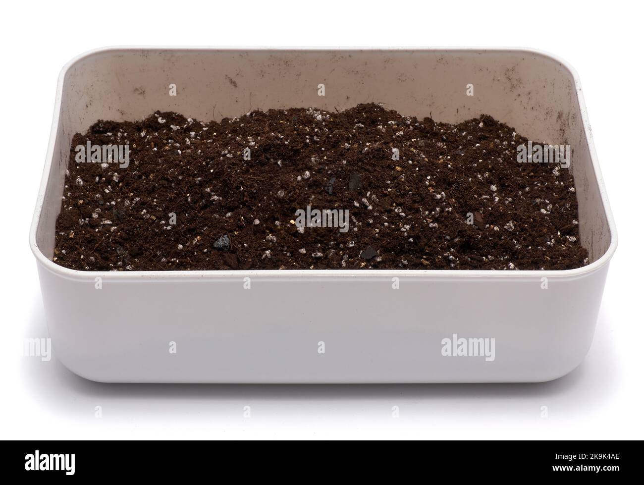 plastic box with substrate soil for transplanting houseplants isolated ...